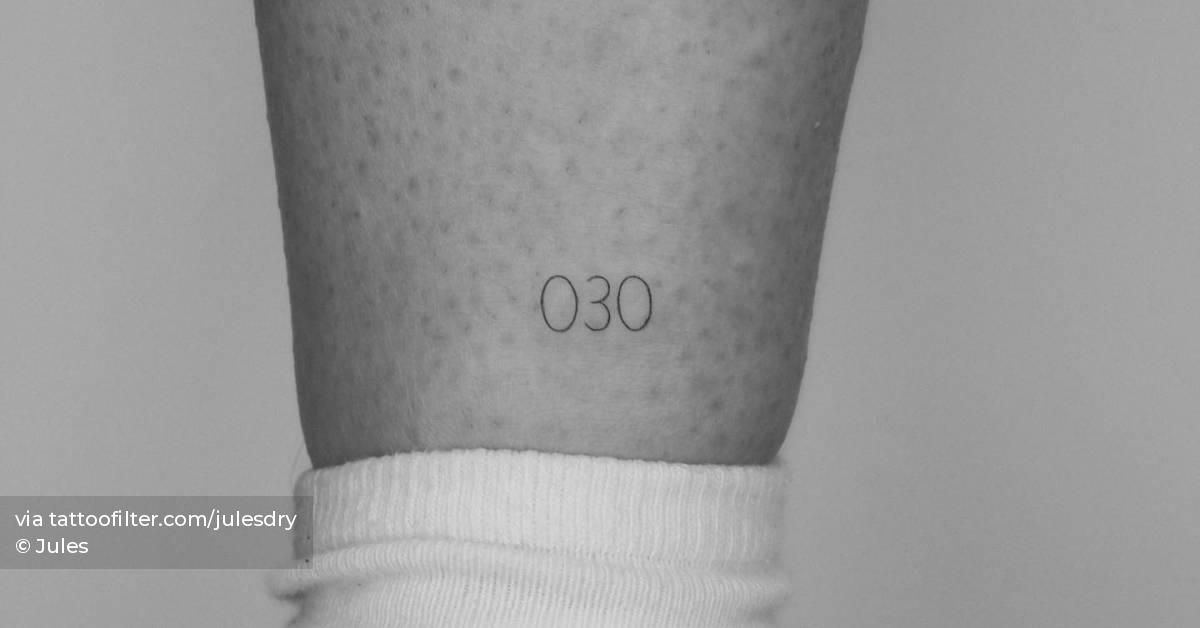 Tattoo of the number "030" located on the shin.