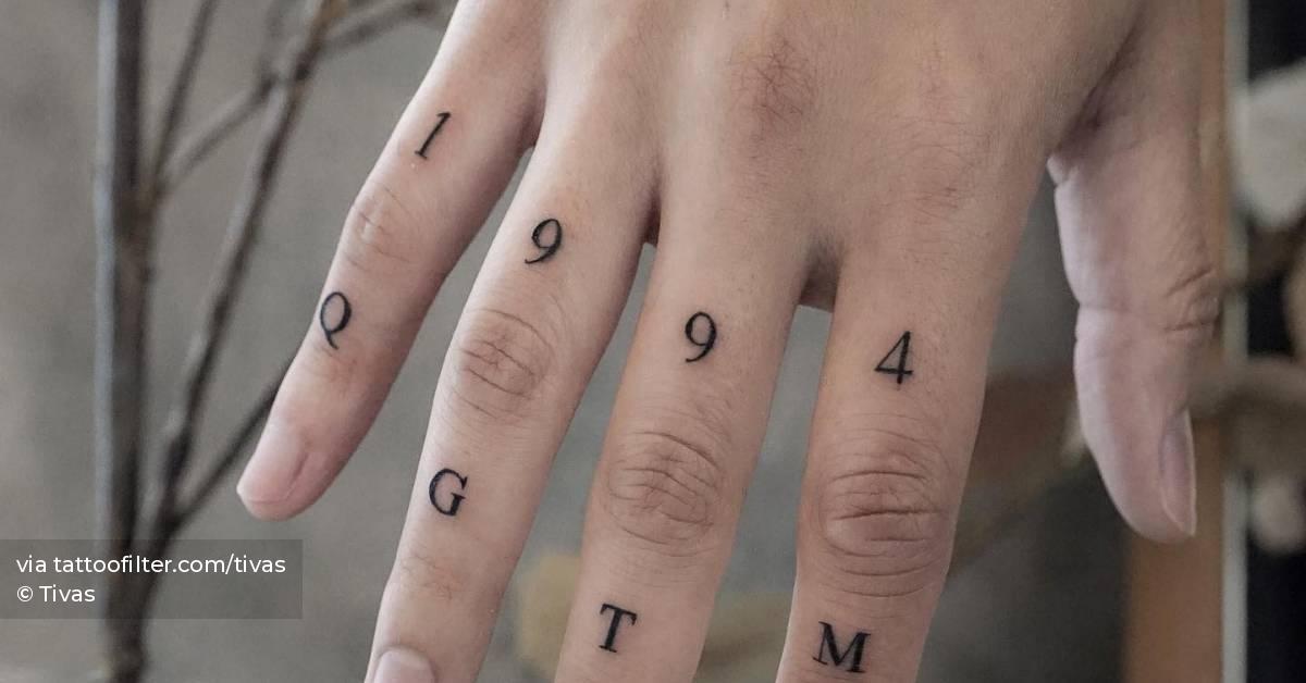 "1994" and initials tattooed on the knuckles and