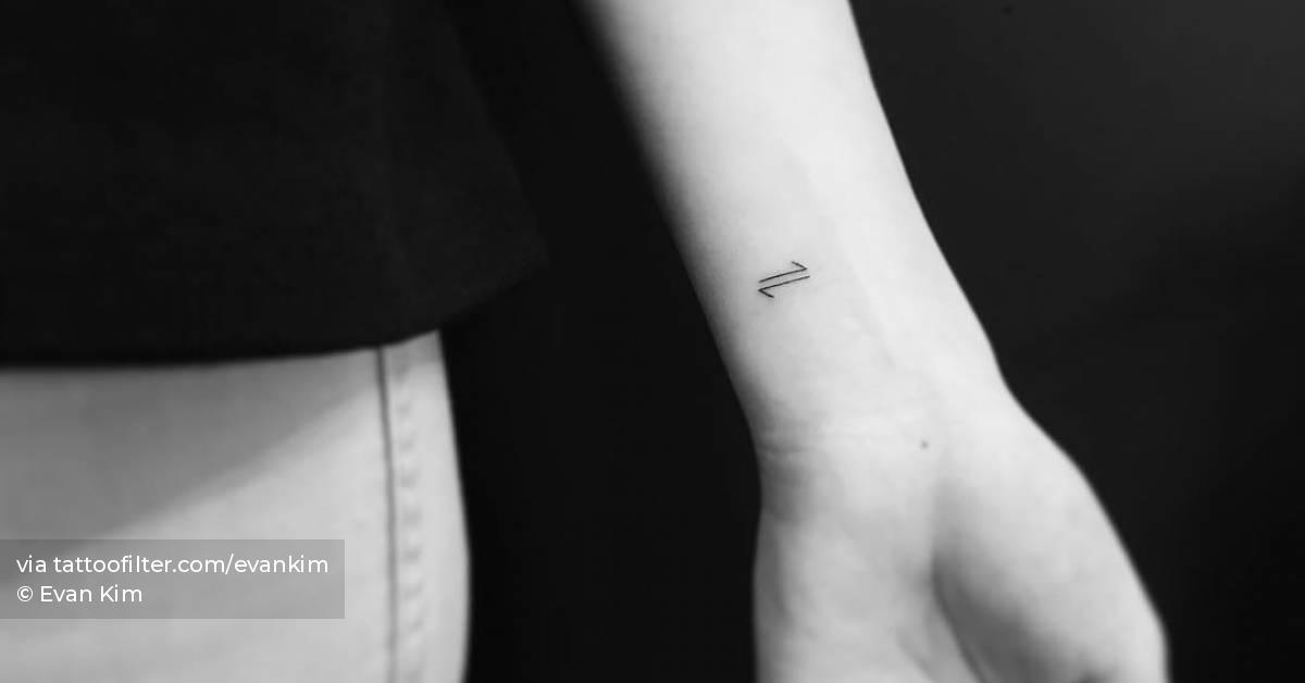 Reversible reaction symbol tattoo located on the wrist.