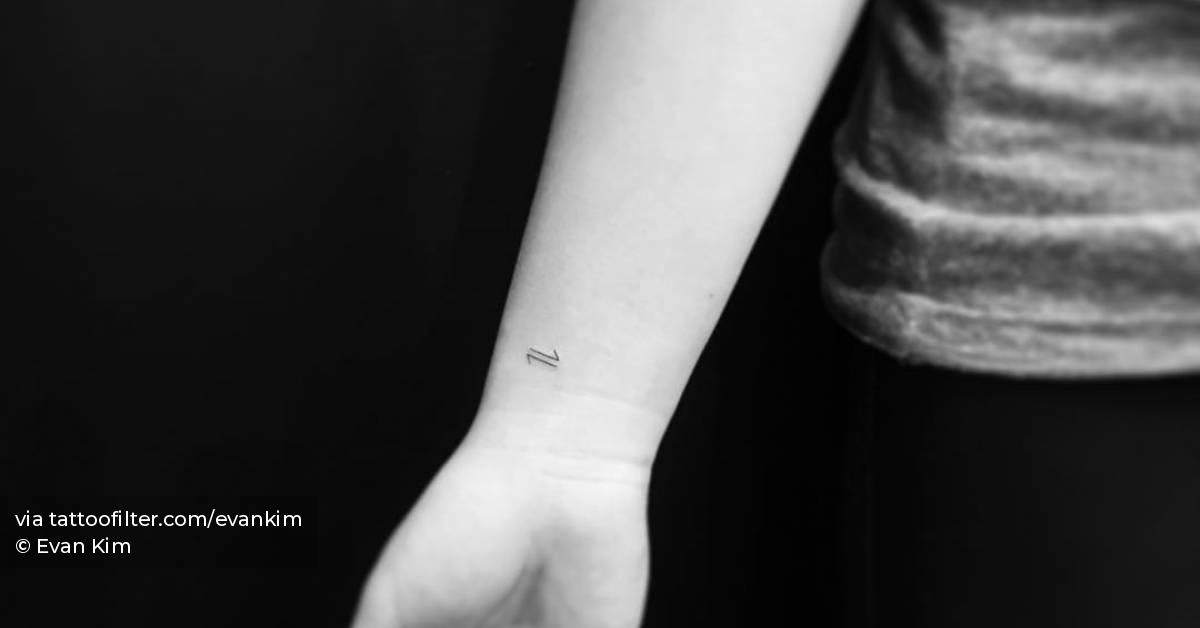 Reversible reaction symbol tattoo located on the wrist.