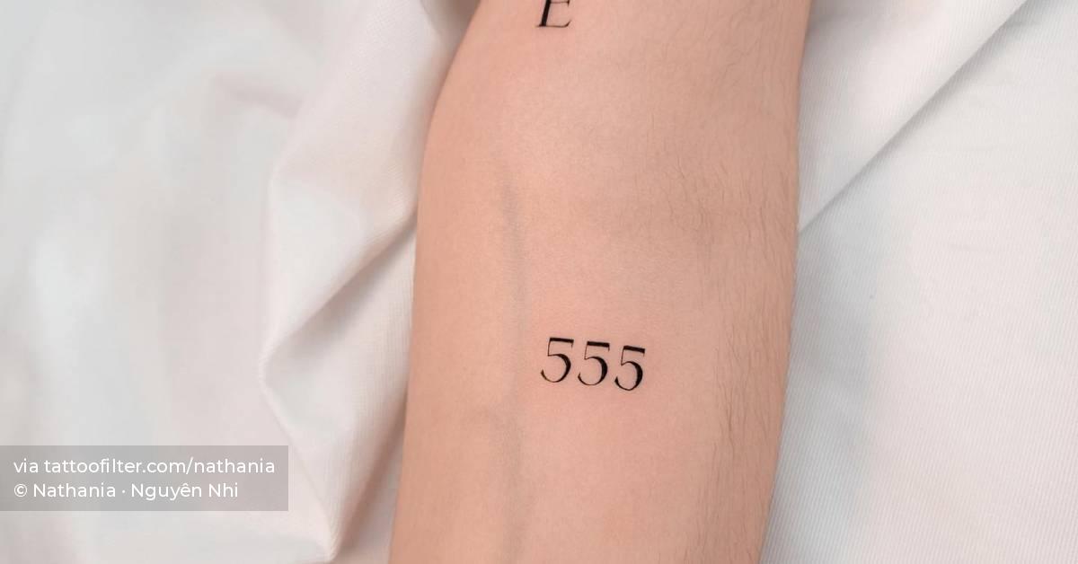 Letter "E" and "555" tattoos located on the arm.