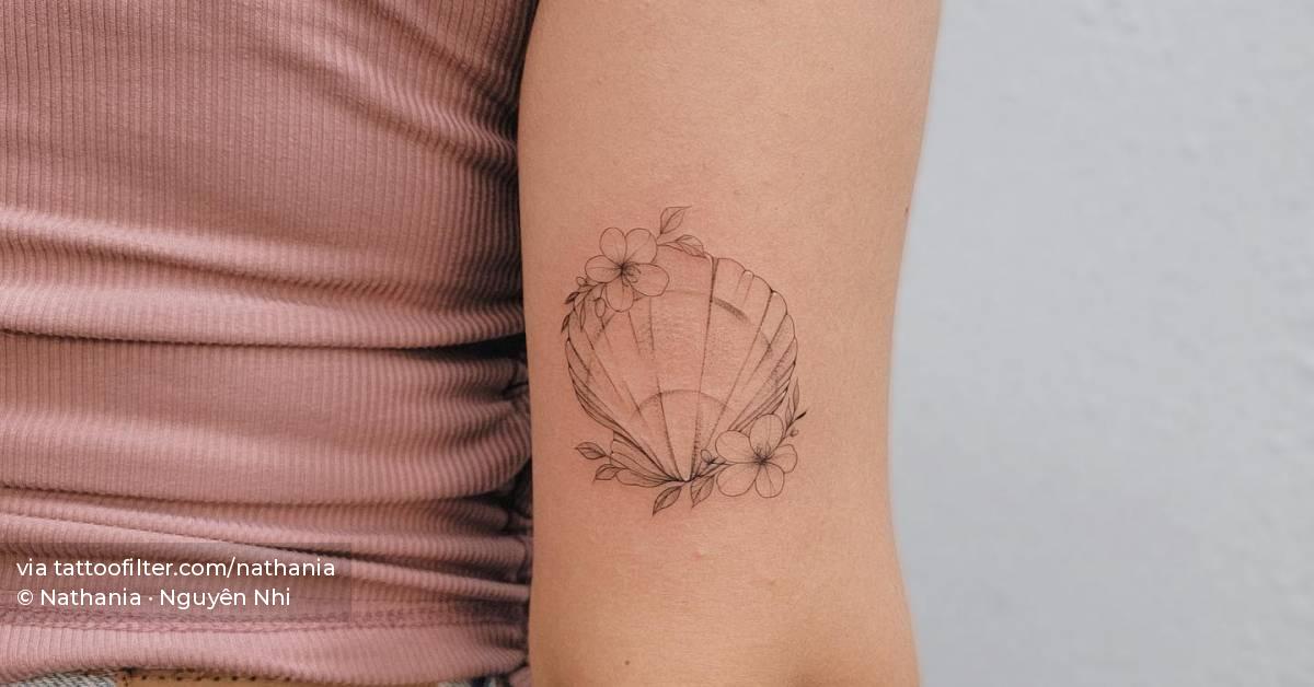 Fine line style shell and flowers tattoo done on the