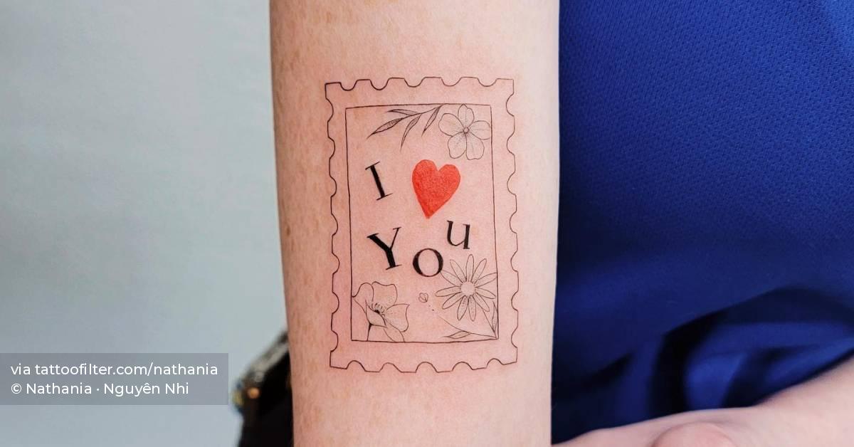 "I love you" stamp tattooed on the upper arm.