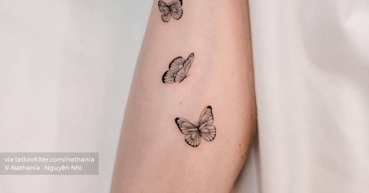 Fine line style butterflies tattooed on the inner