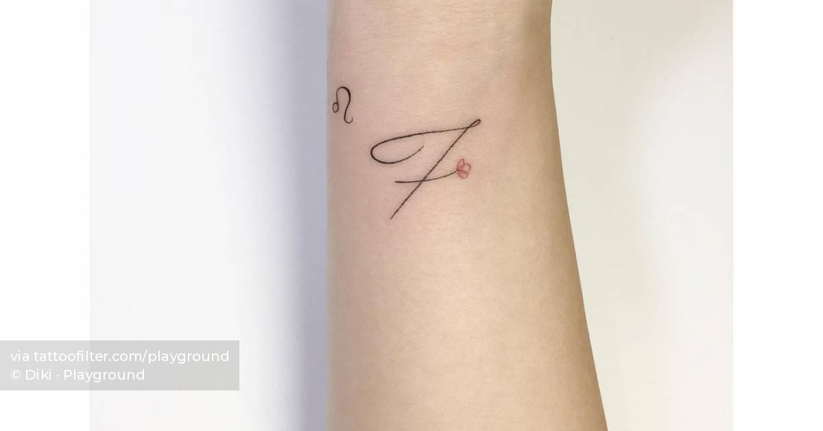 Letter "F" + flower tattooed on the wrist.