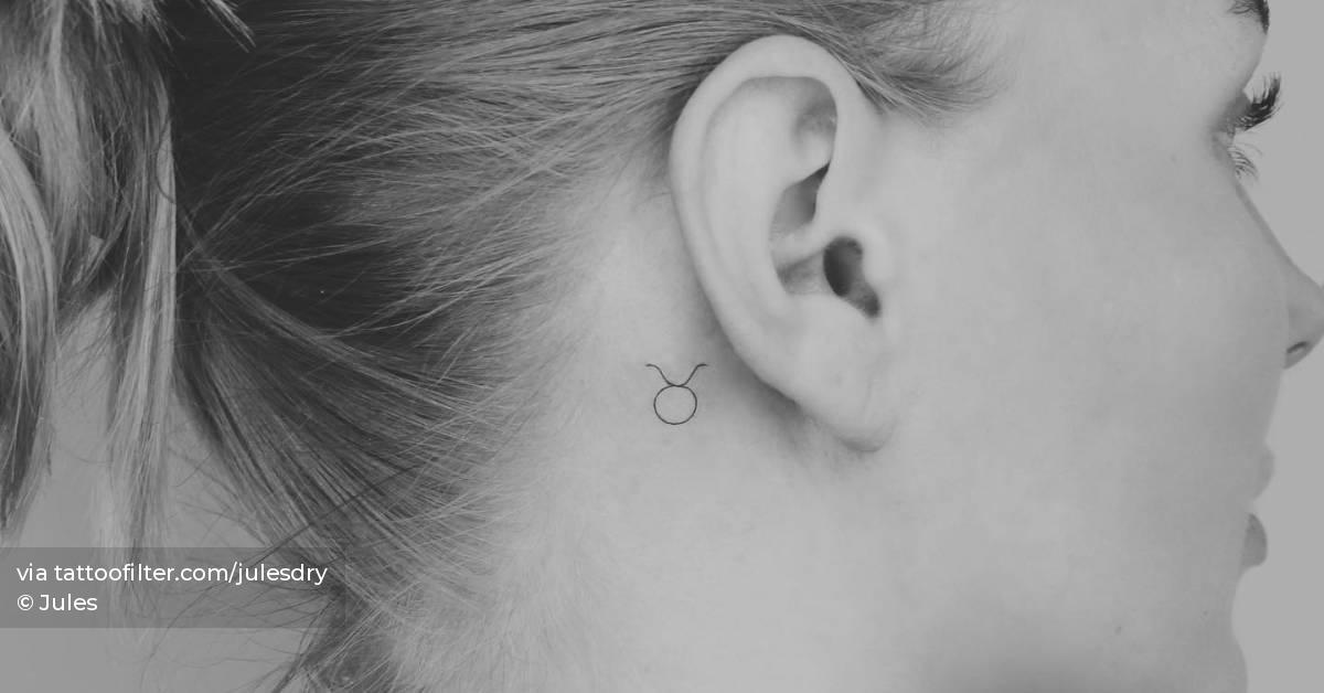 Taurus zodiac symbol tattooed behind the ear.