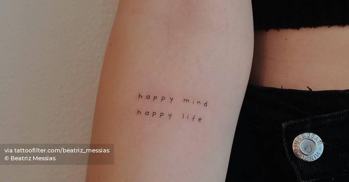 "Happy mind, happy life" handwritten tattoo located on