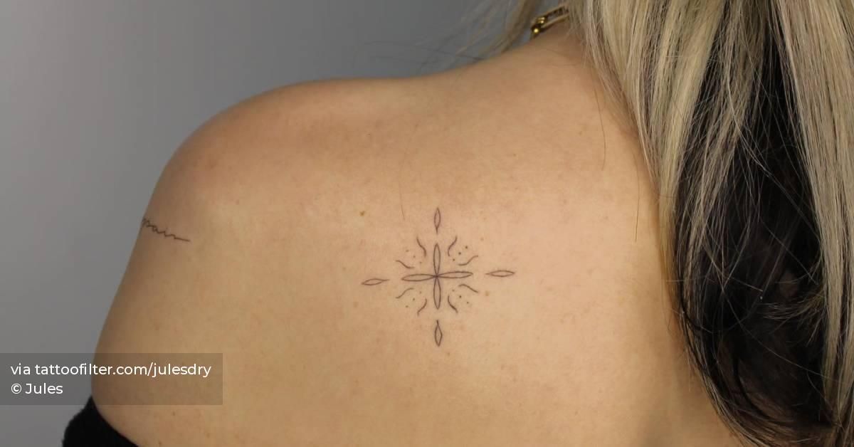 Fine line style ornament tattooed on the shoulder