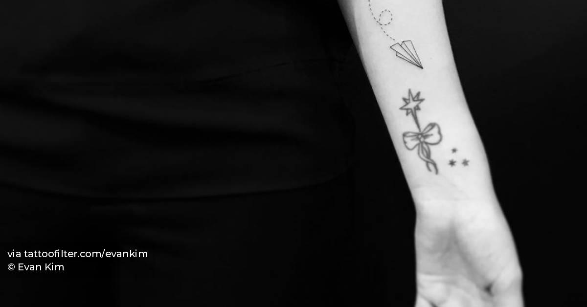 Fine line style paper plane tattoo located on the inner