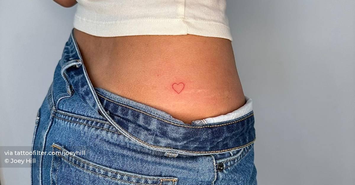 Minimalistic style red heart tattoo located on the hip.