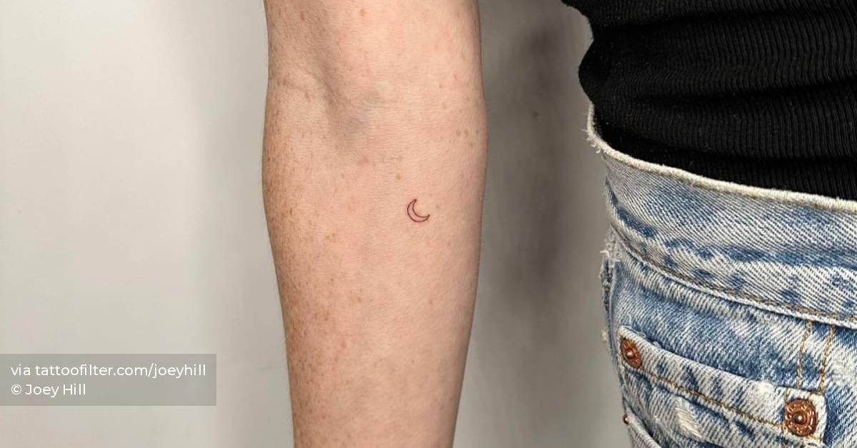 Tiny crescent moon tattoo done on the inner forearm.