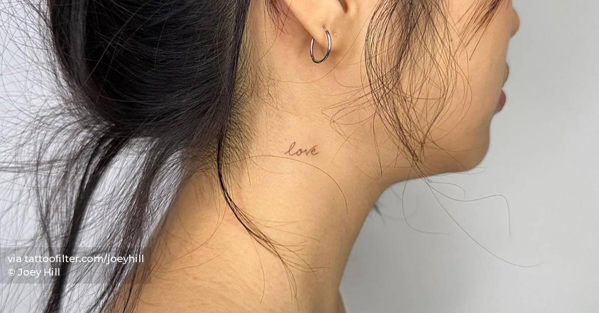 Little tattoo of the word "love" handwritten on the