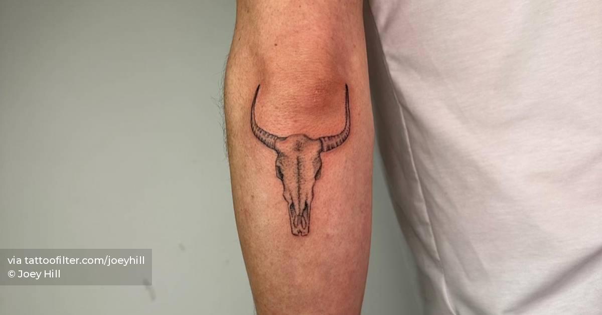 Bull skull tattoo located on the forearm, illustrative