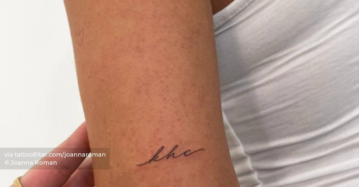 Initials tattoo placed on the tricep.