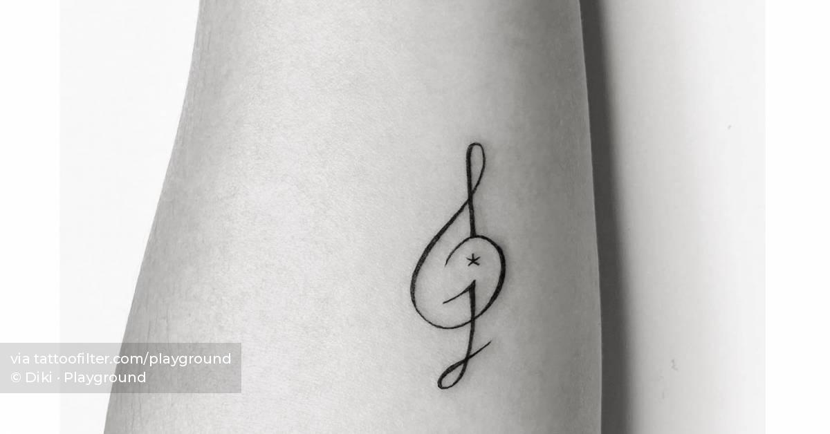 Treble clef tattoo done on the inner forearm.