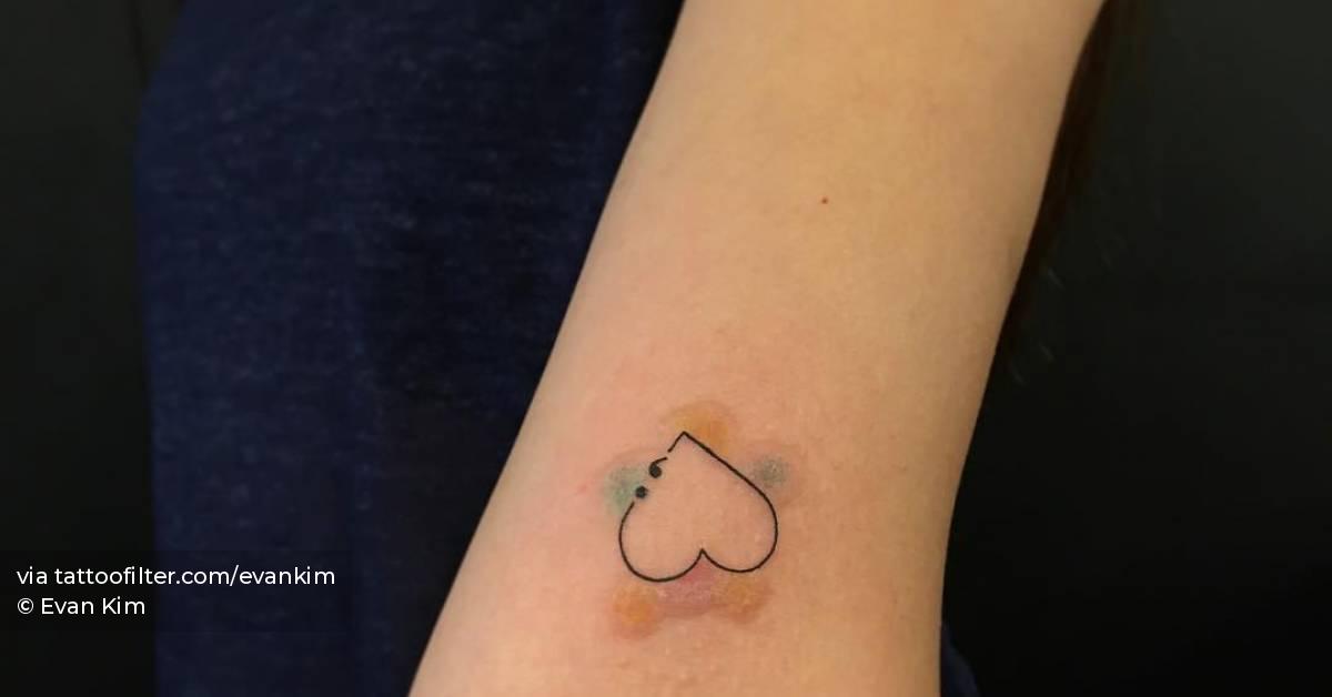 Heart and semicolon tattoo located on the bicep.