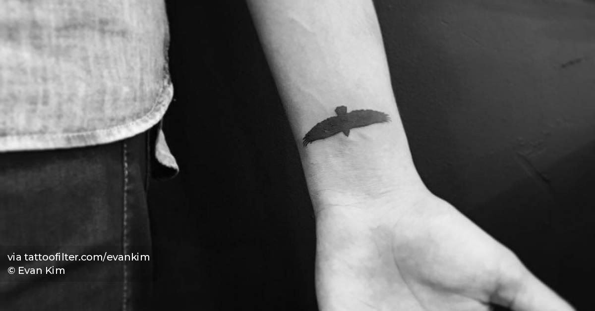 Minimalistic hawk tattoo located on the wrist.