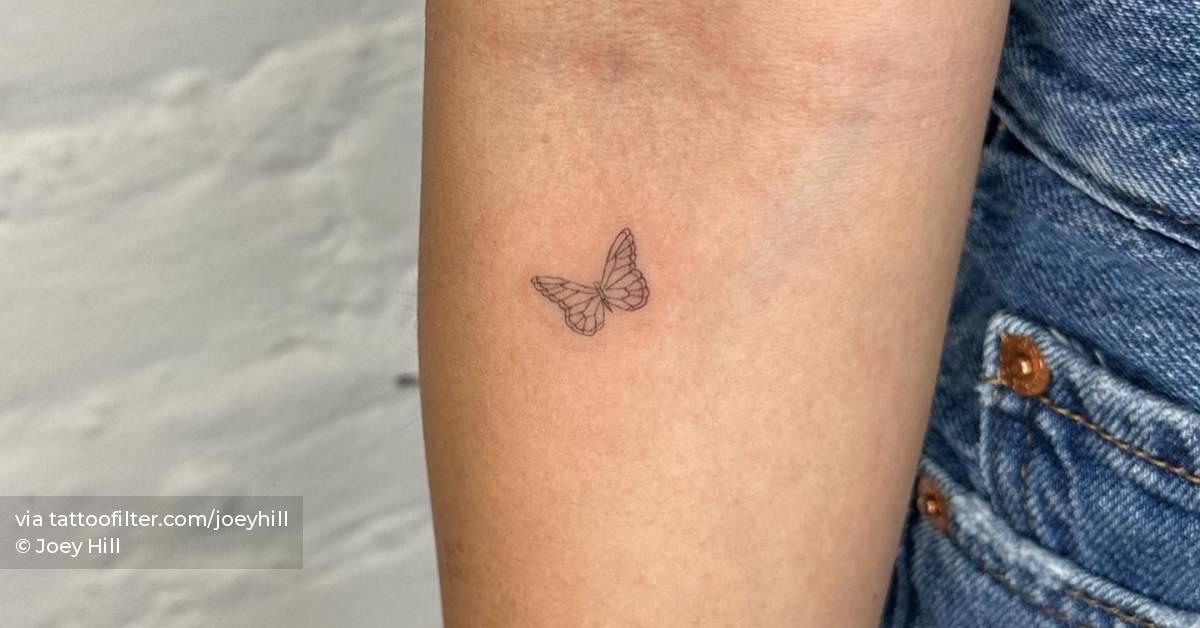 Tiny fine line butterfly tattoo done on the inner