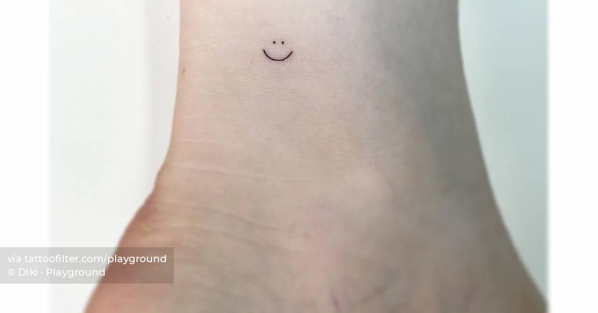 Cute little smiley face tattoo done on the ankle,