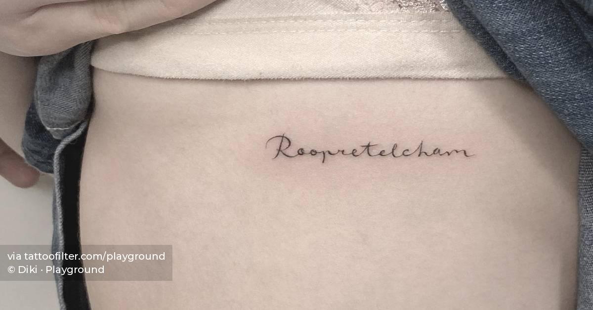 "Roopretelcham" lettering tattoo located on the rib.