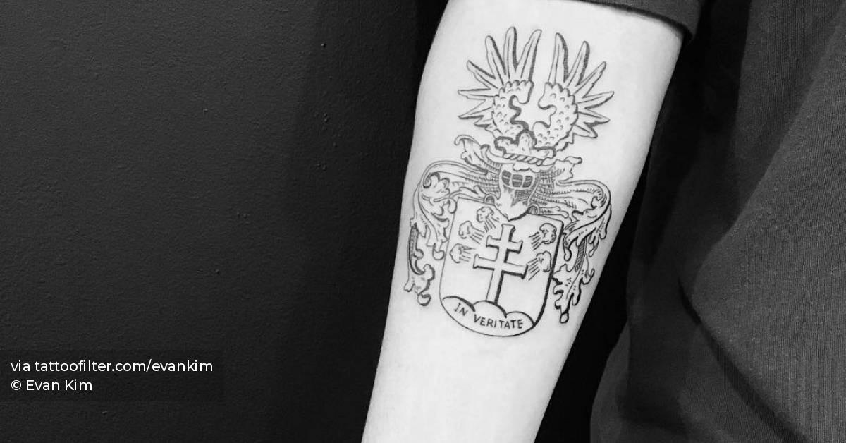 Crest tattoo located on the inner forearm.