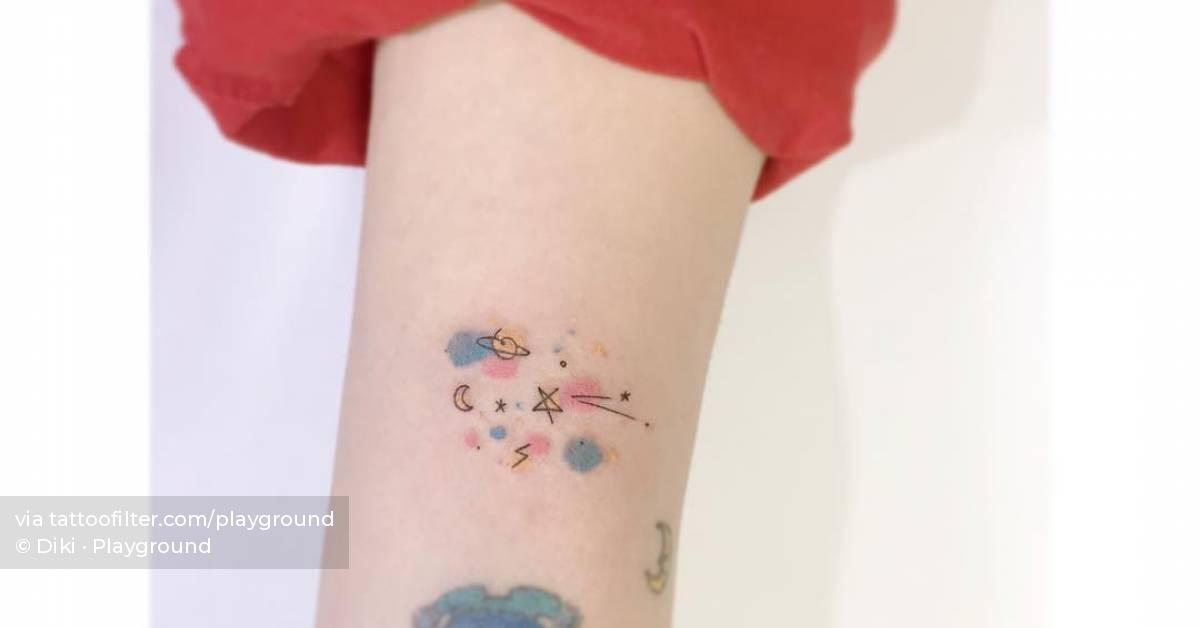 Minimalistic universe tattoo located on the bicep.