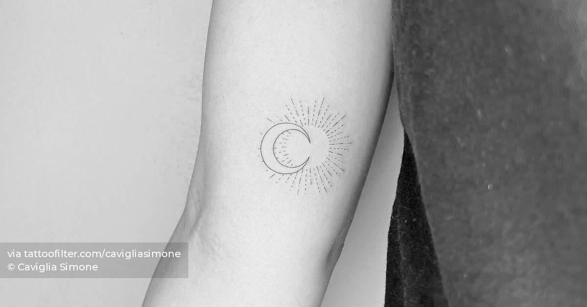 Fine line style eclipse tattoo done on the inner arm.