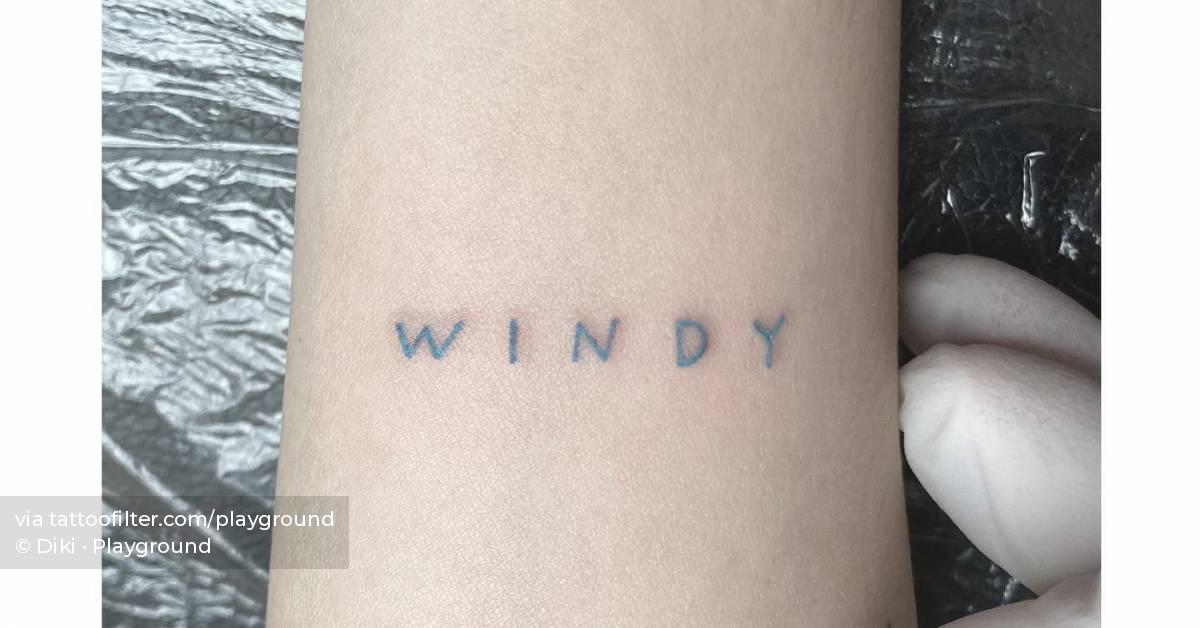 "Windy" lettering tattoo in blue ink, located on the
