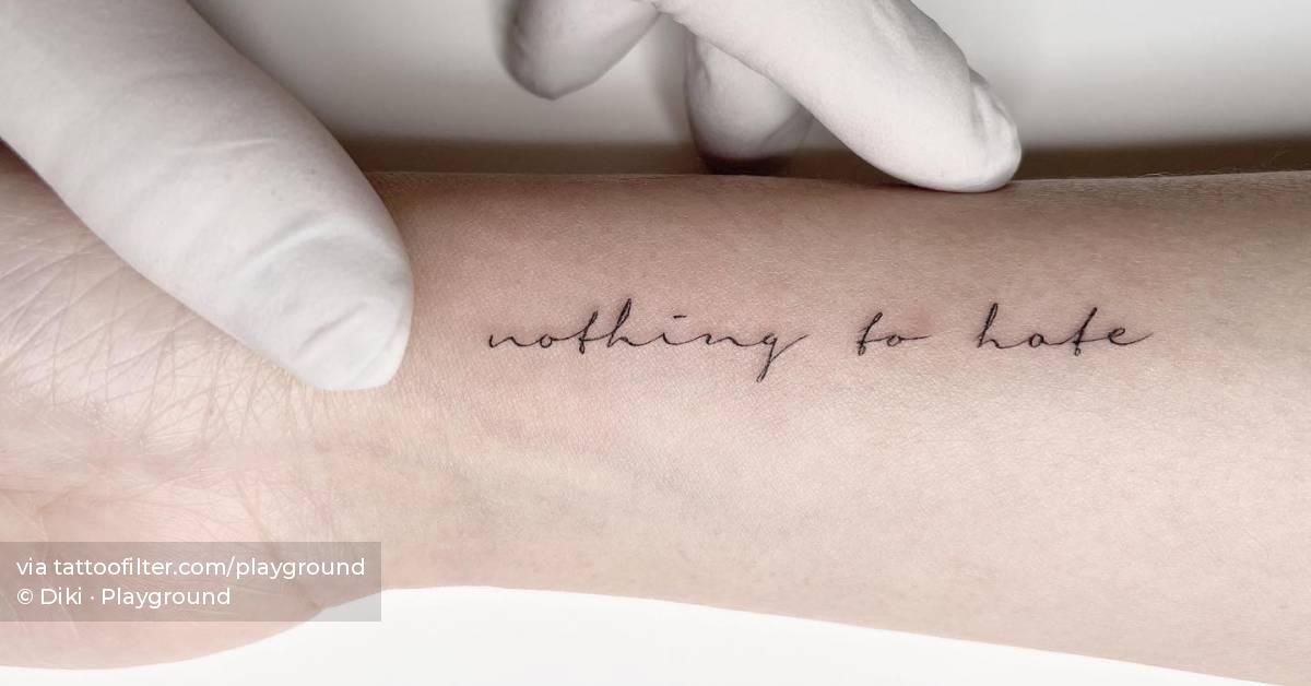 Tattoo that says "nothing to hate" handwritten on the