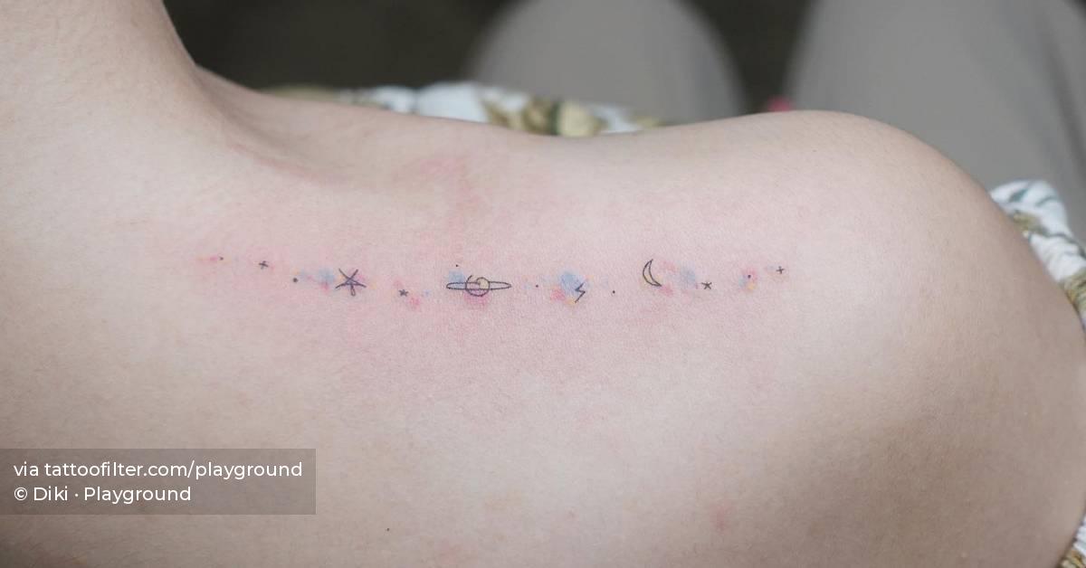 Universe tattooed on the top of shoulder, minimalistic