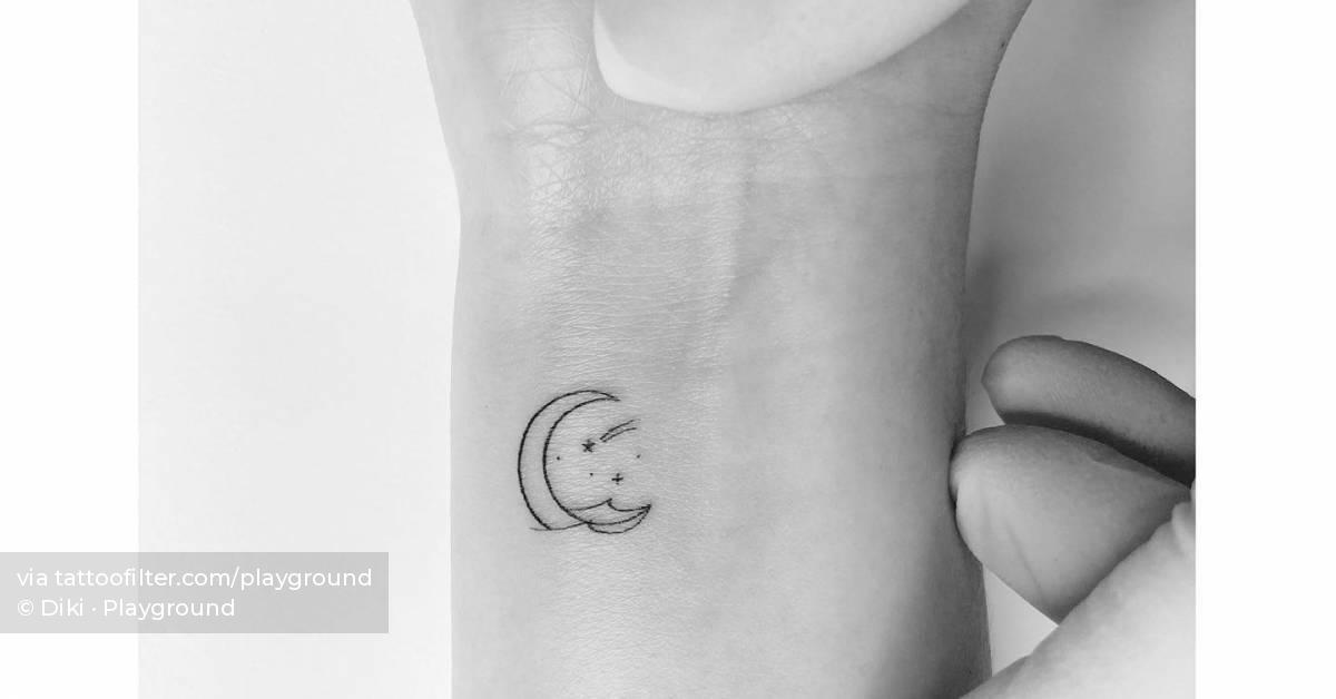 Wave, moon and stars tattooed on the wrist.