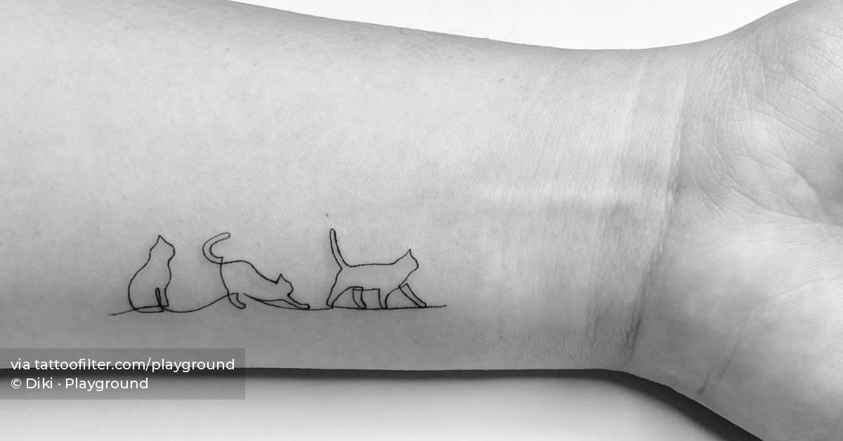 One line style cats tattooed on the wrist.