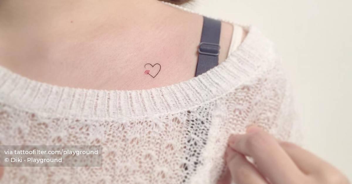 Flower heart tattoo located on the collarbone,