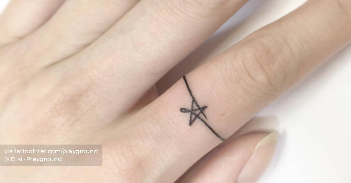 Star ring tattoo located on the finger, minimalistic