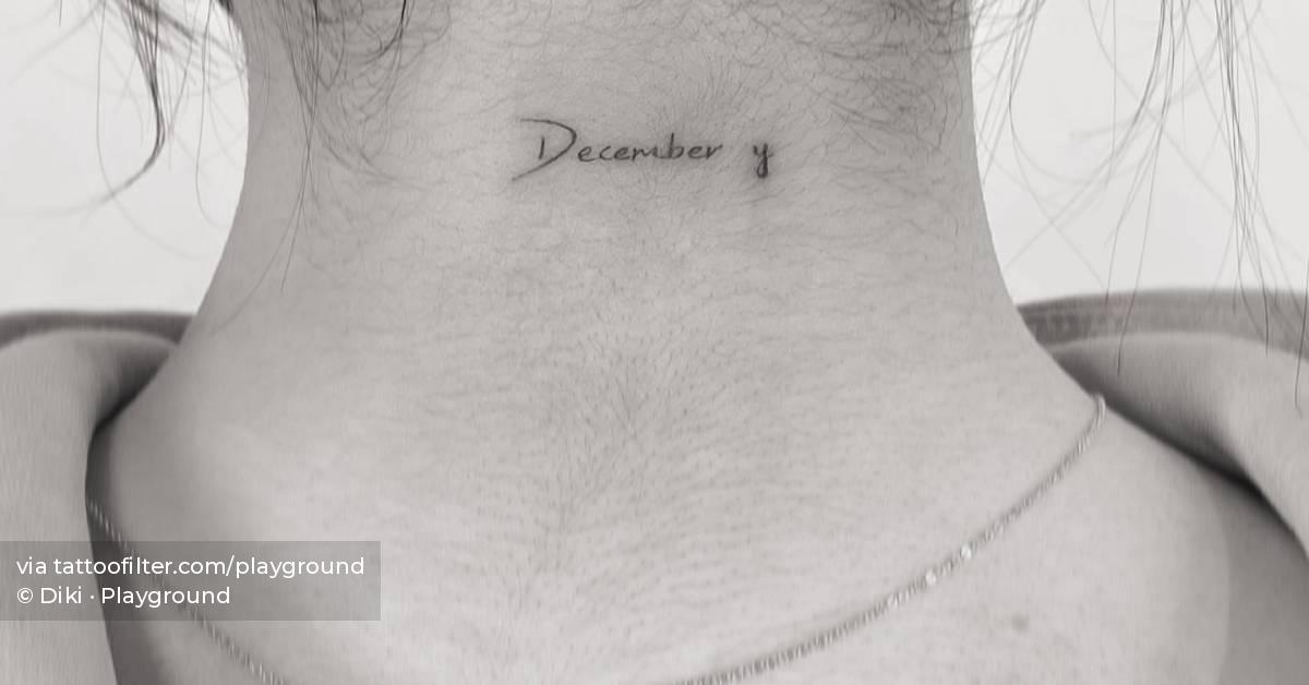 Tattoo of the word "December" located on the back of