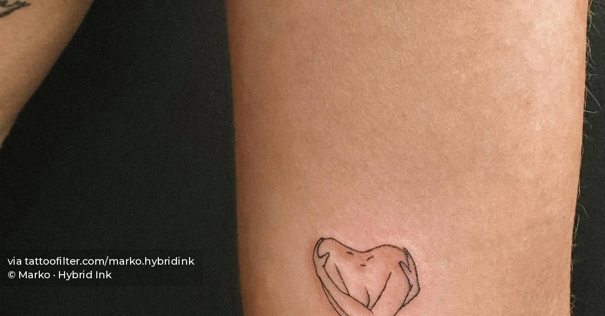 Minimalistic self hug tattoo located on the inner arm,