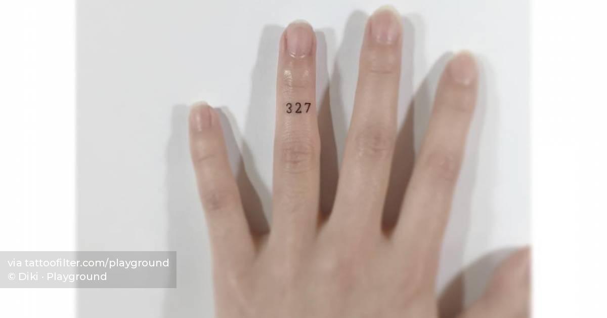 Tattoo of the number "327" located on the finger.