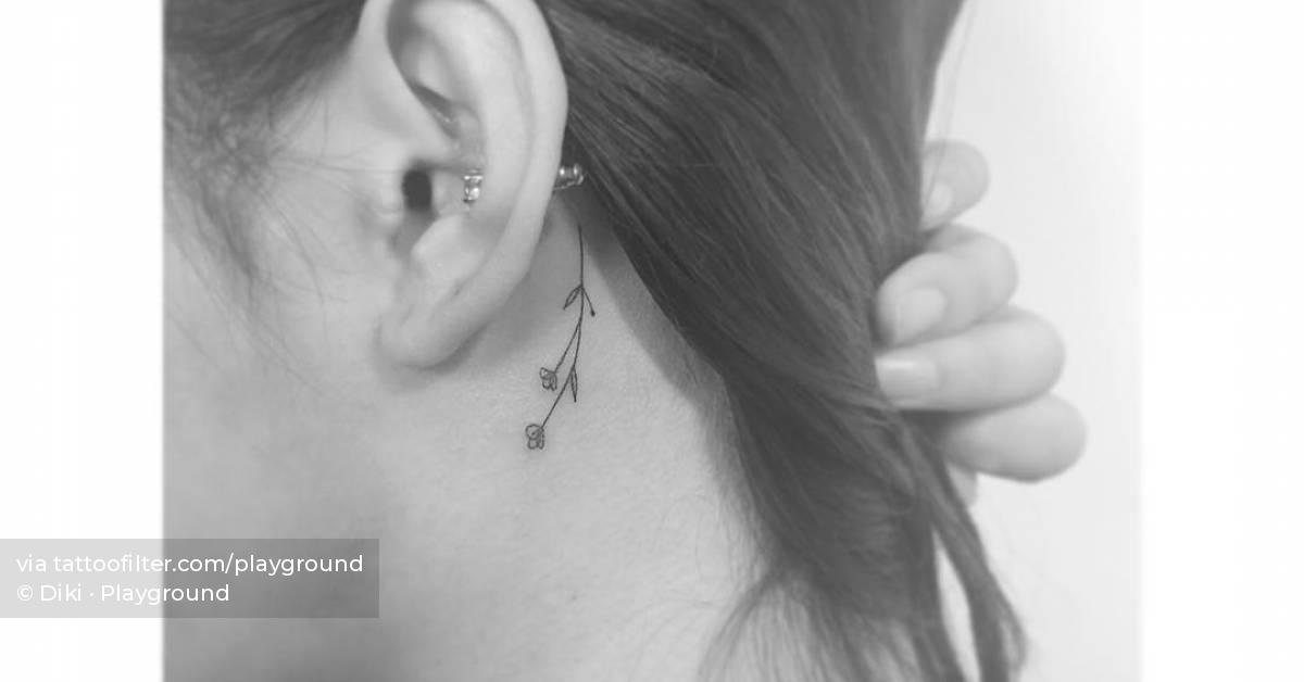 Fine line style flowers tattooed behind the ear.