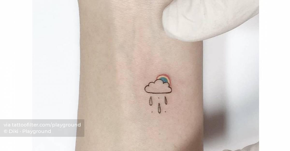 Rain and rainbow tattooed on the wrist, minimalistic