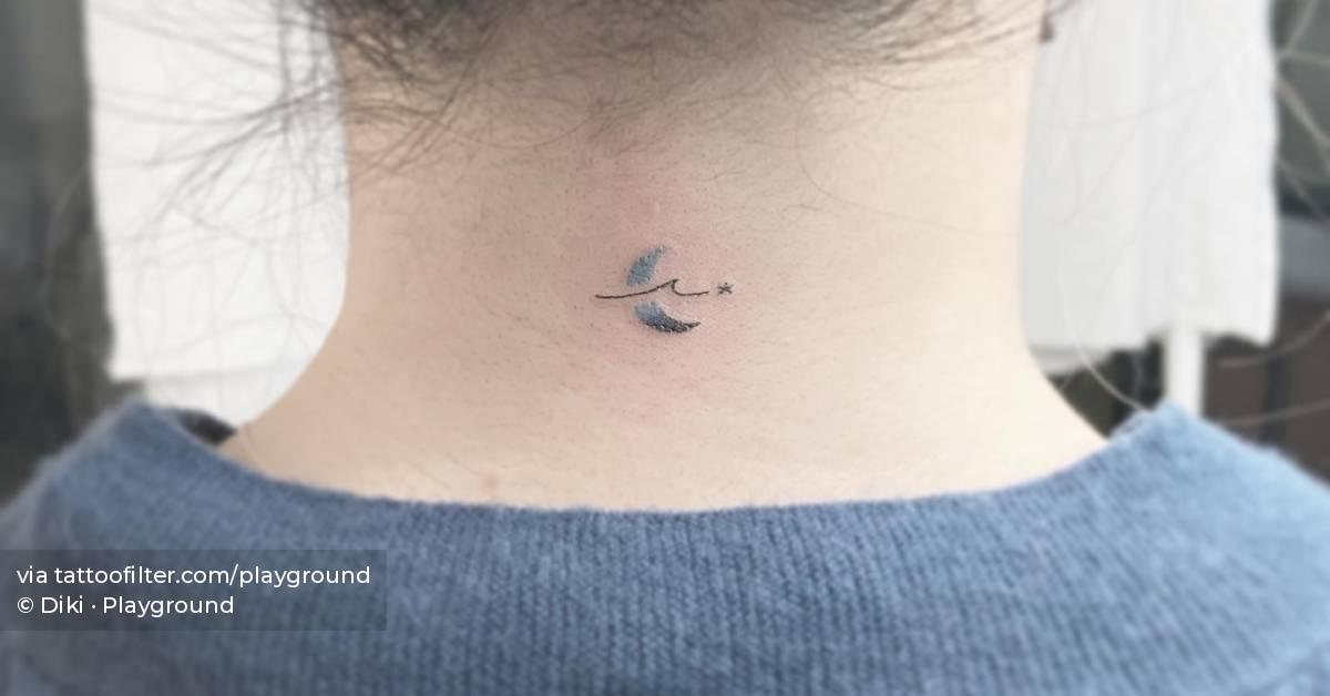 Crescent moon, wave and star tattooed on the back of