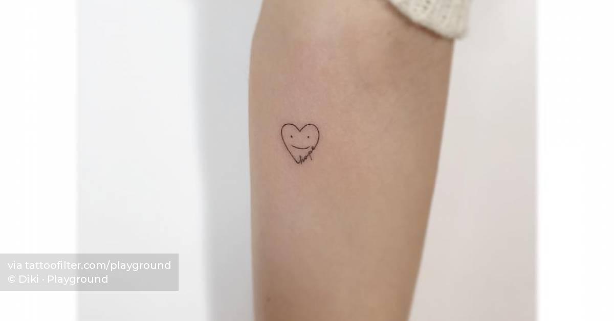 Smiley heart and word "hope" tattooed on the inner