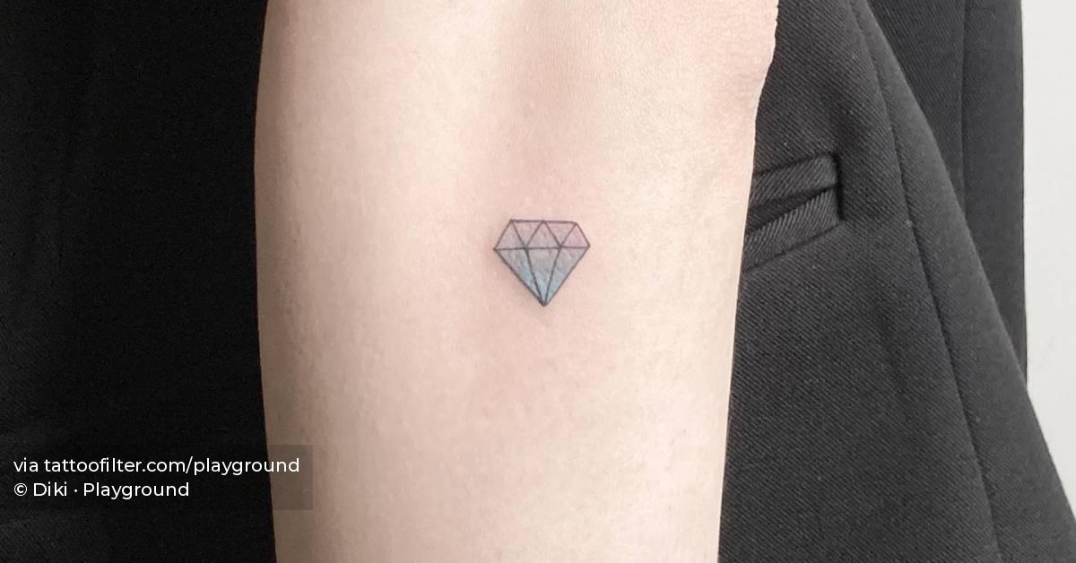 Spectrum diamond tattoo located on the inner forearm.