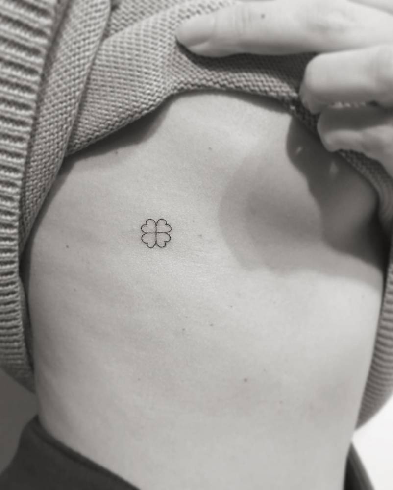 Tiny Four Leaf Clover Tattoo Located On The Rib 