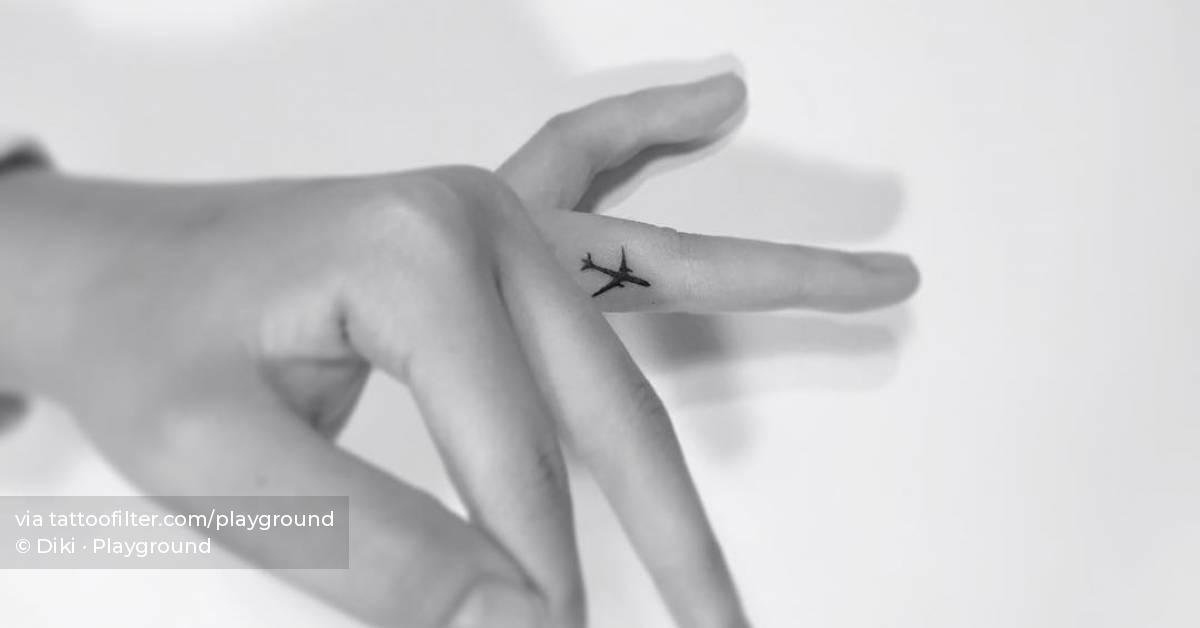 Cute tiny plane tattoo done on the finger, minimalistic
