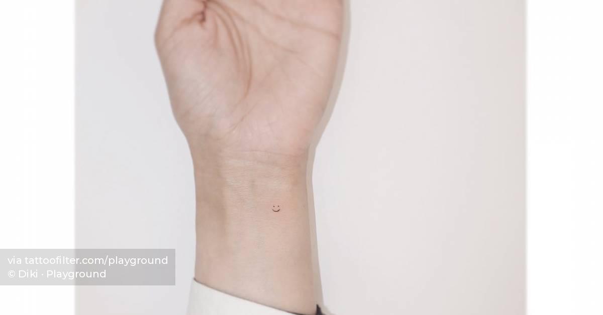 Micro smiley face tattoo done on the wrist.