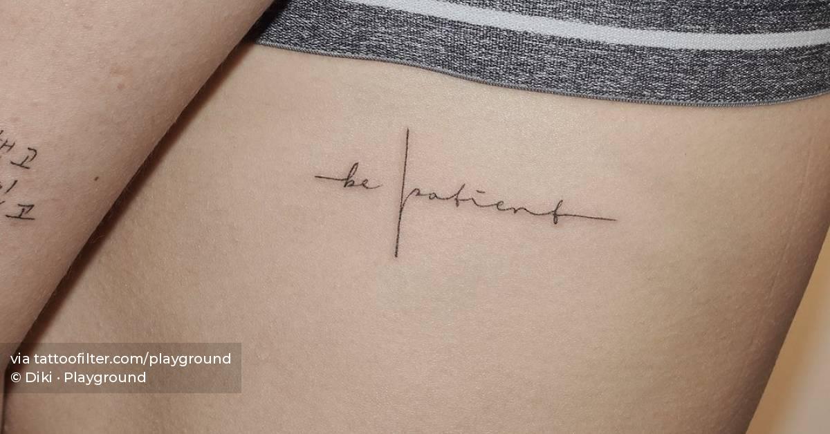 Lettering cross that says "be patient" tattooed on the