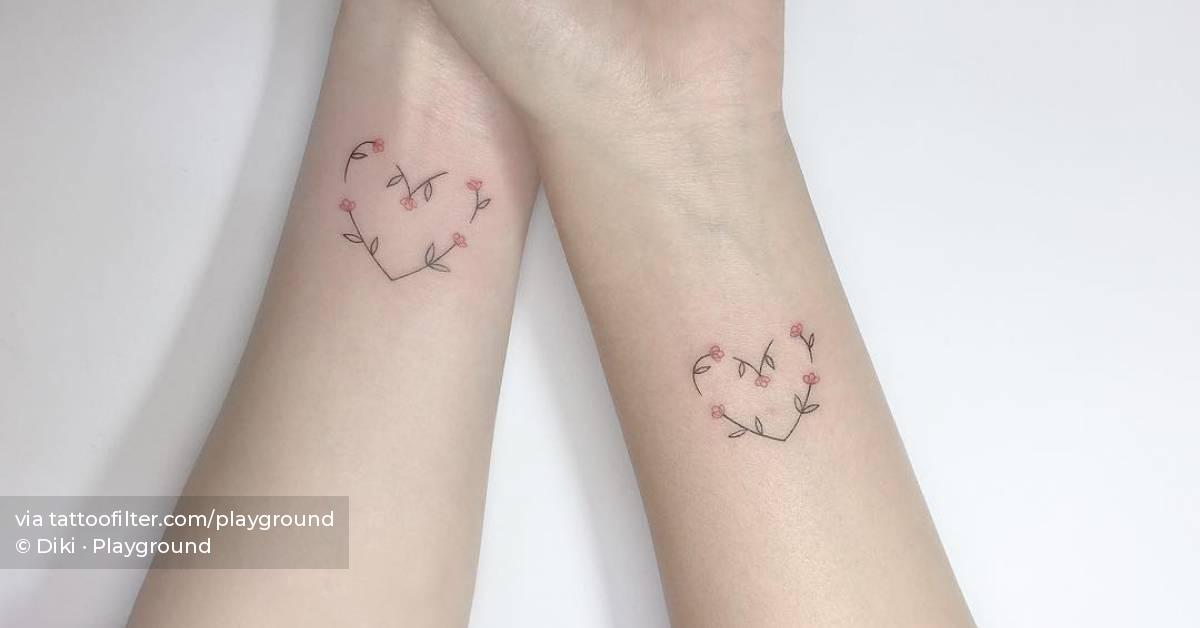 Matching flower heart tattoo for couple.