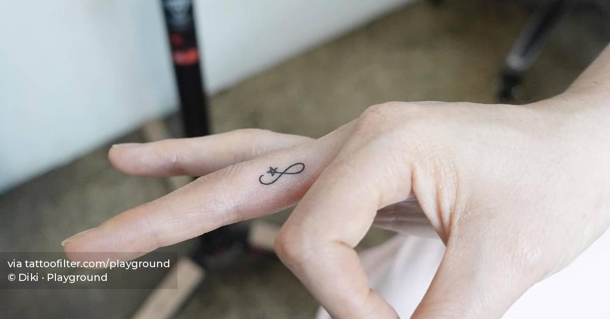Minimalistic infinity symbol and star tattooed on the