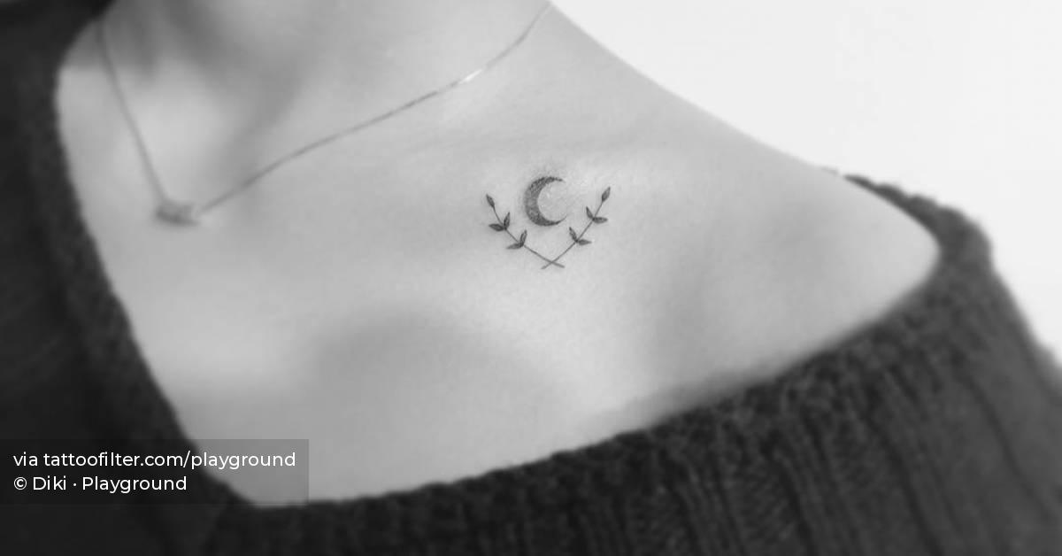 Laurel wreath and moon tattoo placed on the collarbone.