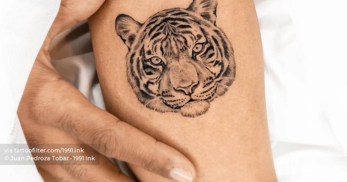 Tiger head tattoo done on the inner forearm.